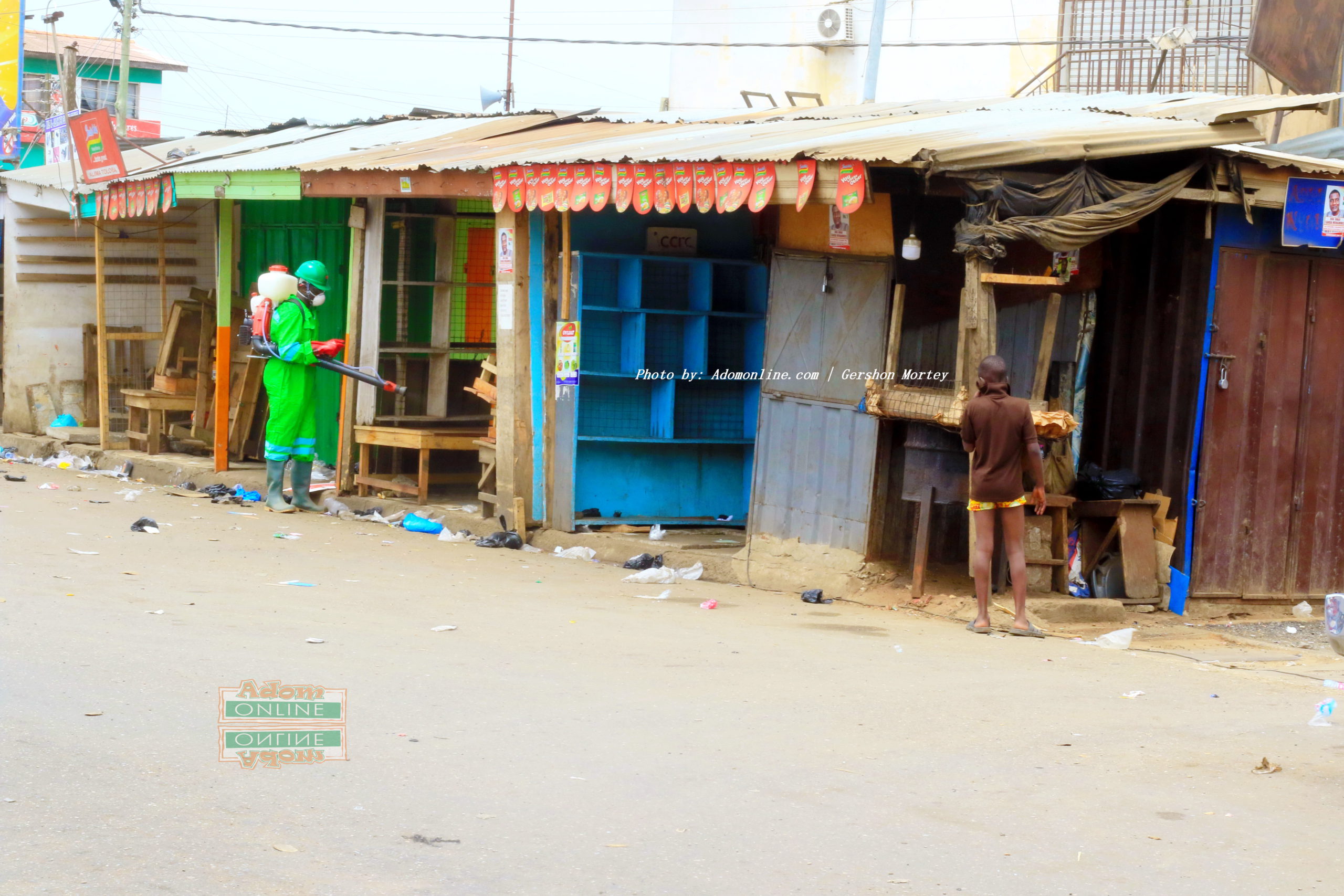 Boy watches on unprotected in market disinfection exercise