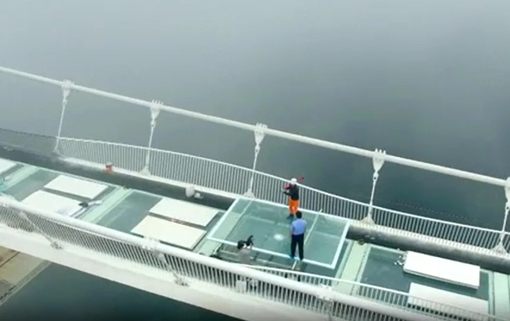 China: Man left dangling from bridge after glass breaks - Adomonline.com