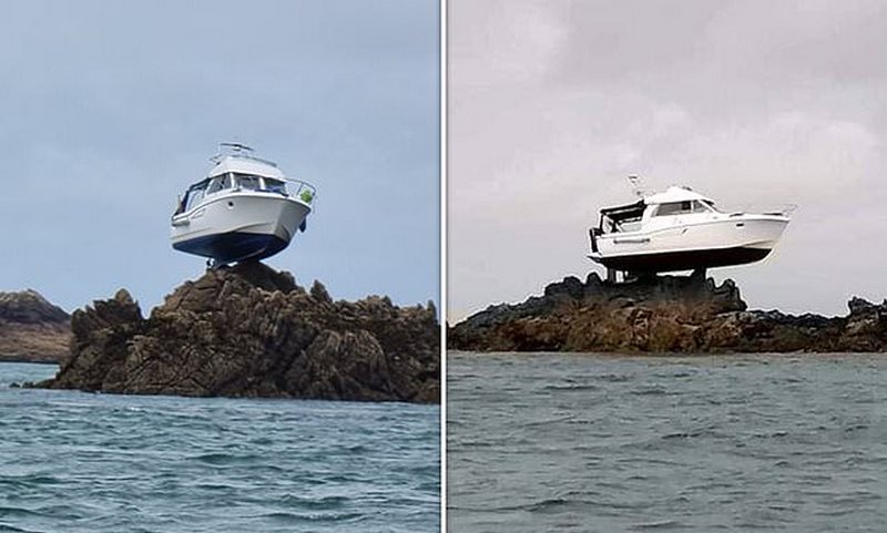 Scary moment boat gets stuck on top of rock 10ft in the air after ...